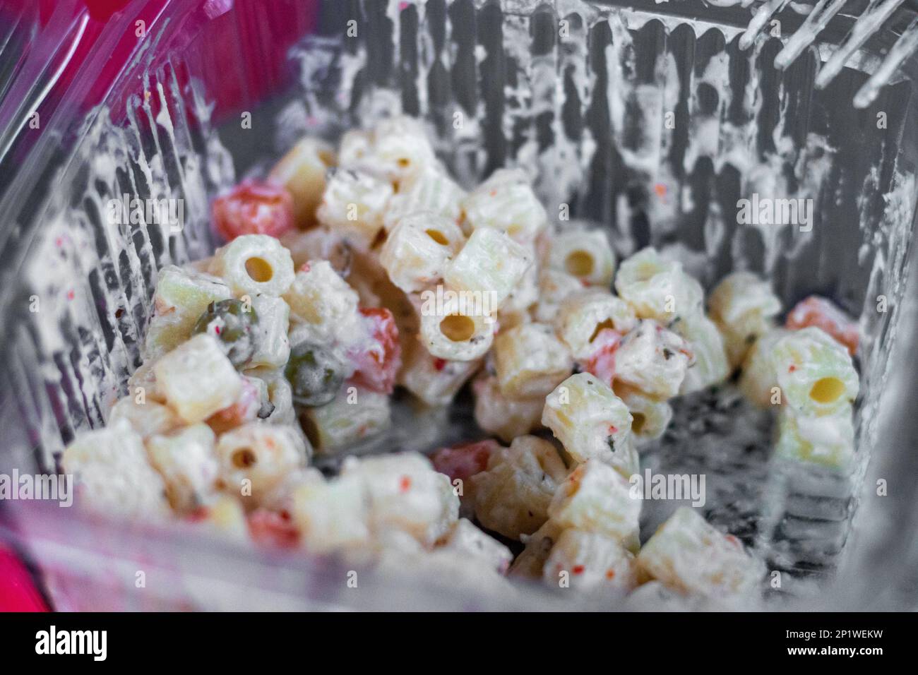 A plastic container of macaroni salad . Noise and grain included Stock ...