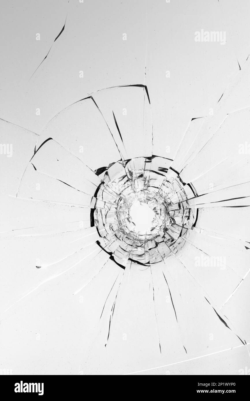 Cracked glass with bullet hole resembling spider web pattern Stock ...