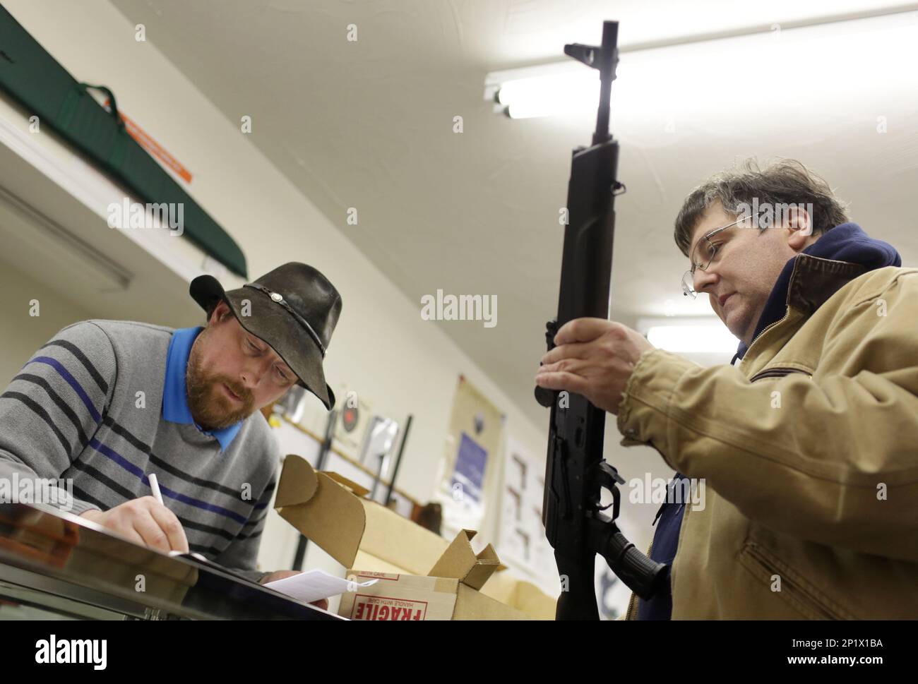 Joe McGrew, right of Lake Ariel, Pa., inspects his new Saiga AK-47 ...