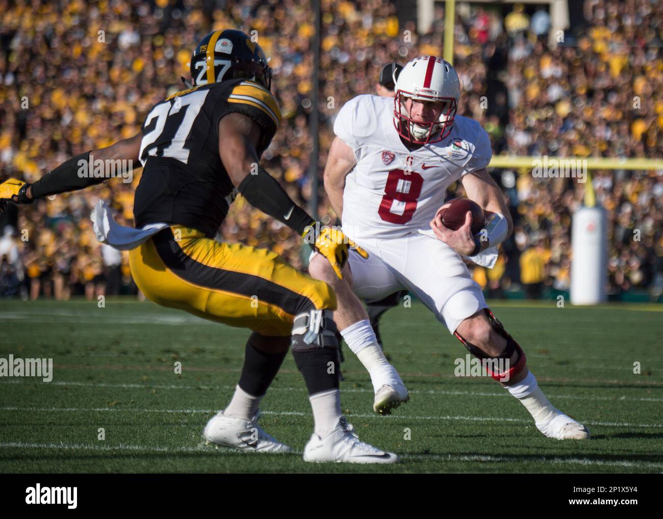 Stanford Cardinal quarterback Kevin Hogan (8) eludes Iowa Hawkeyes ...