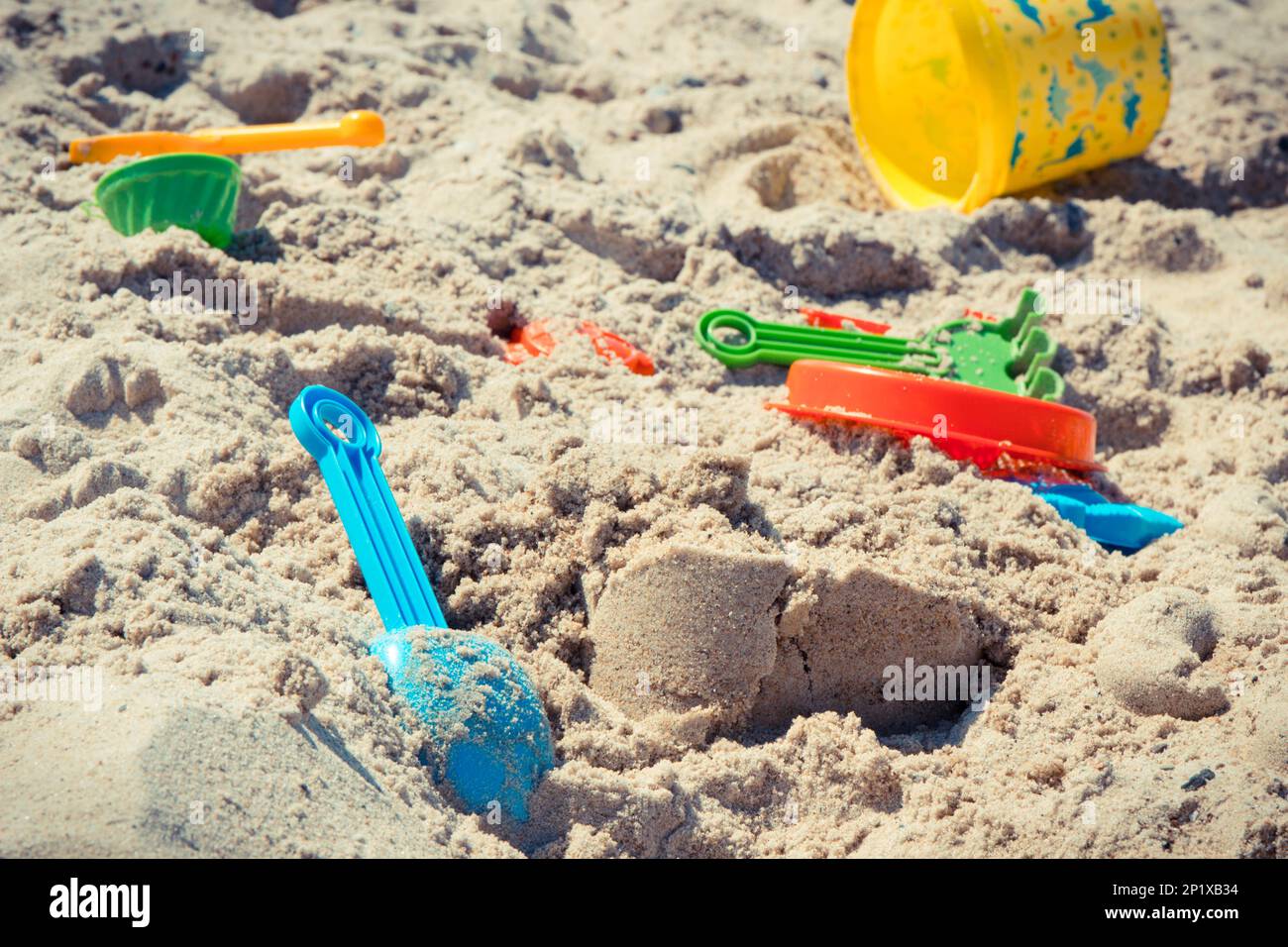 Different shapes made of sand and children toys for relax or playing on ...