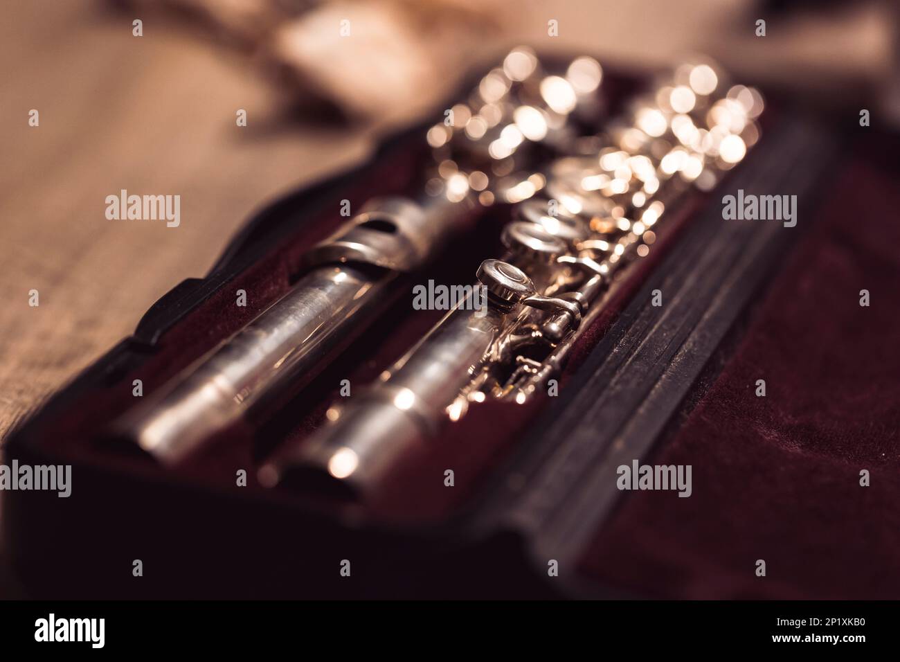 A portrait of a valve of a disassembled metal silver flute in a case ...