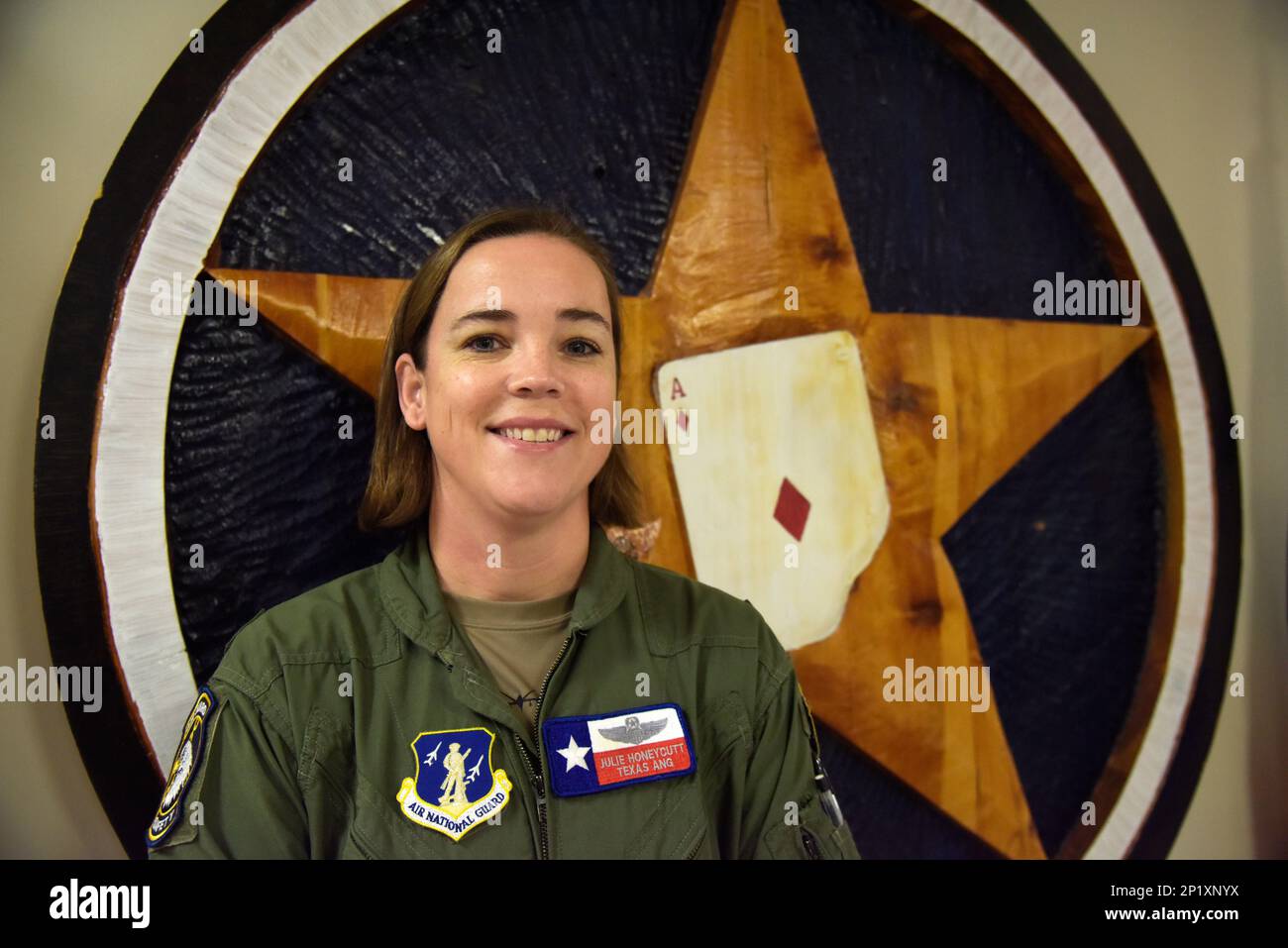 Lt. Col. Julie Honeycutt poses in front of an Ace in the Hole carving ...