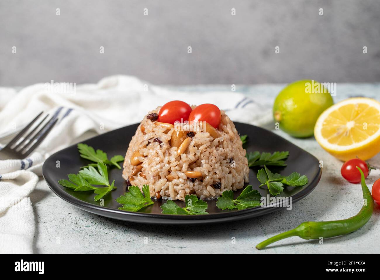 Rice rice with pine pistachios and almonds on a gray floor. Bademli ic ...