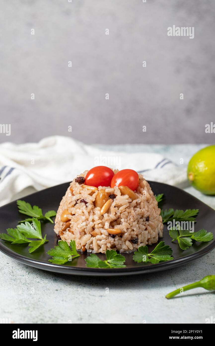 Rice rice with pine pistachios and almonds on a gray floor. Bademli ic ...