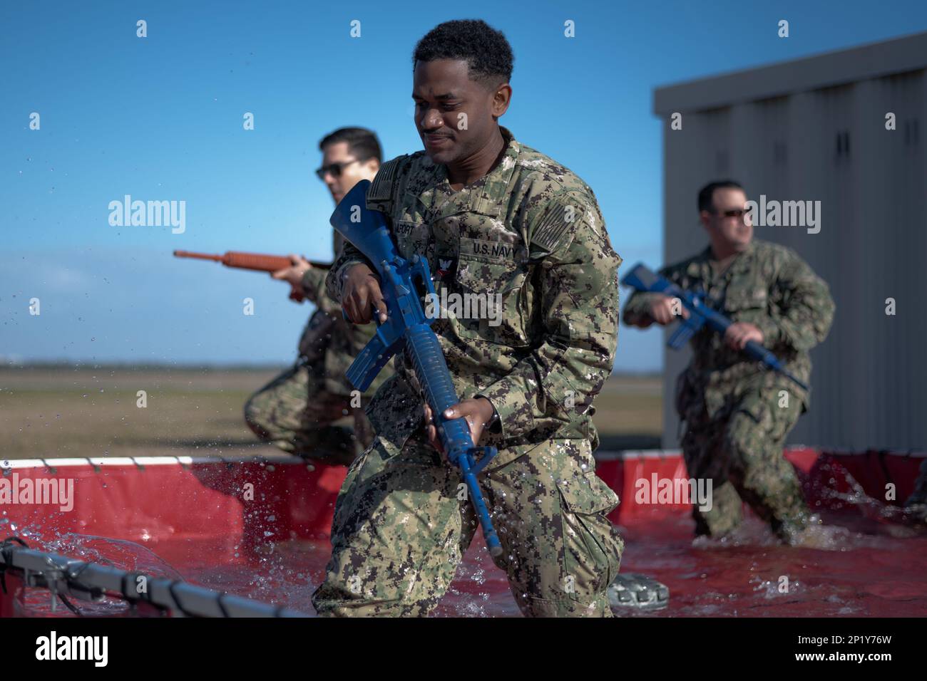 U.S. Navy corpsmen cross a water pit during Operation Blue Horizon at ...