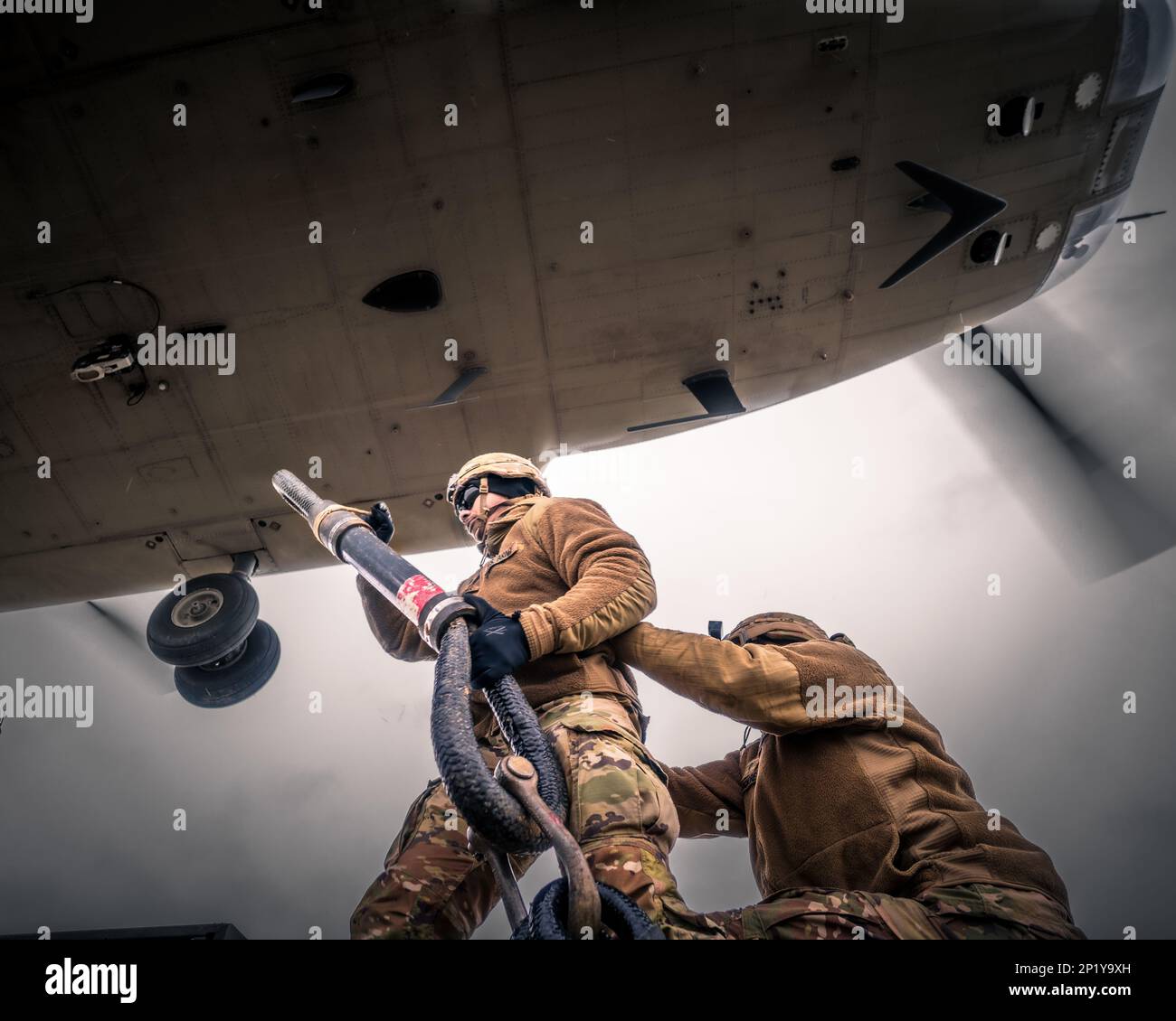 U.S. Army air defenders attach their Avenger weapon system to a Chinook ...