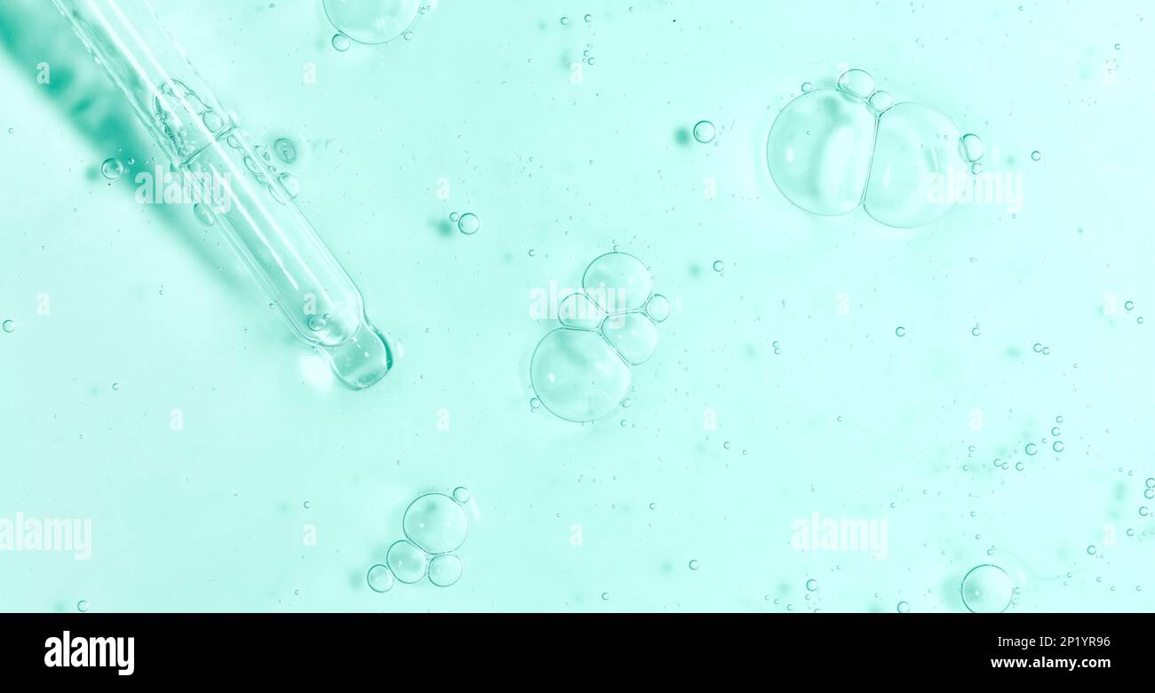 Cosmetic serum texture with dropper transparent liquid green background ...