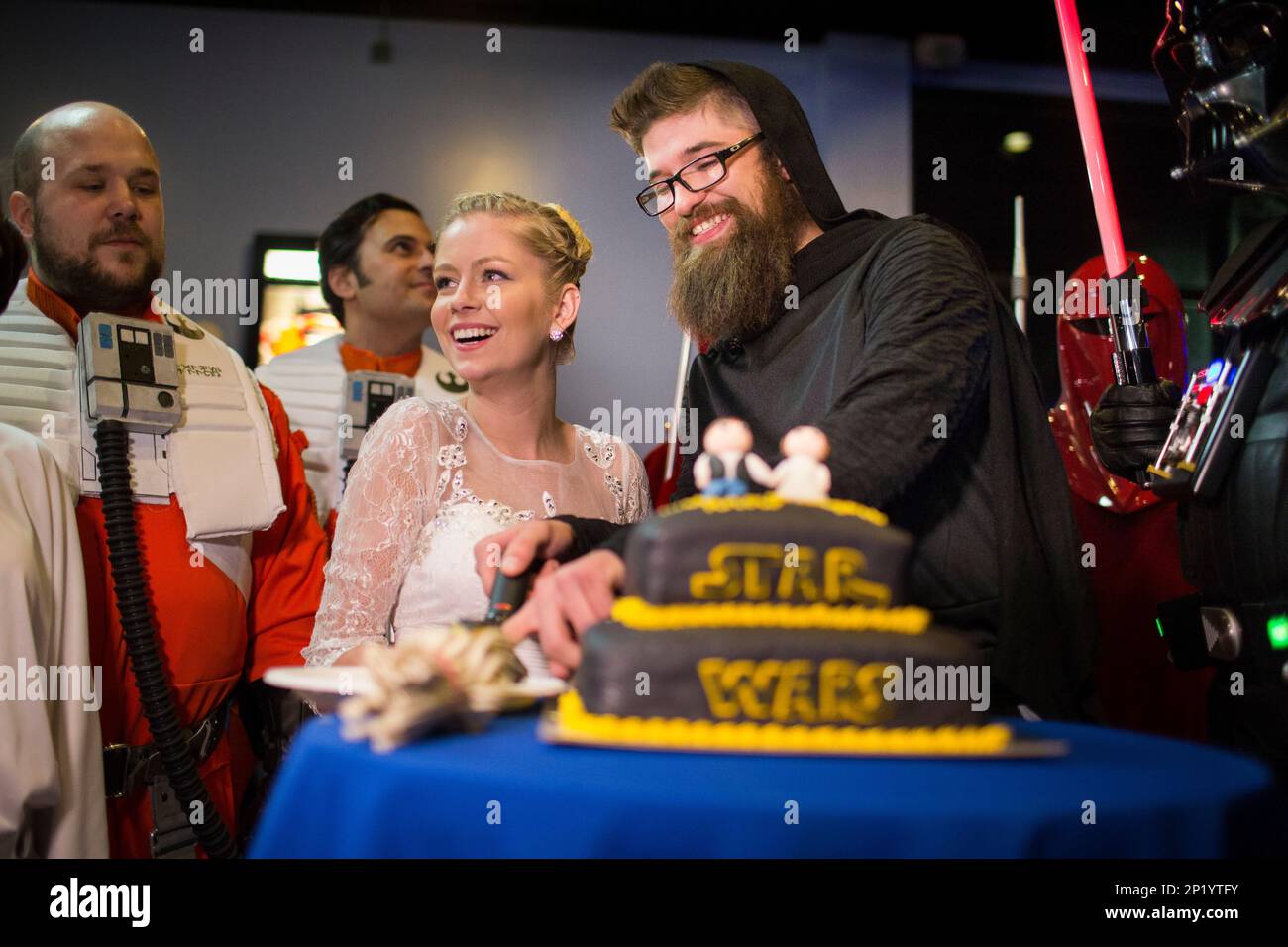 Meg Thompson and Anthony Nygren cut a Star Wars wedding cake during a ...