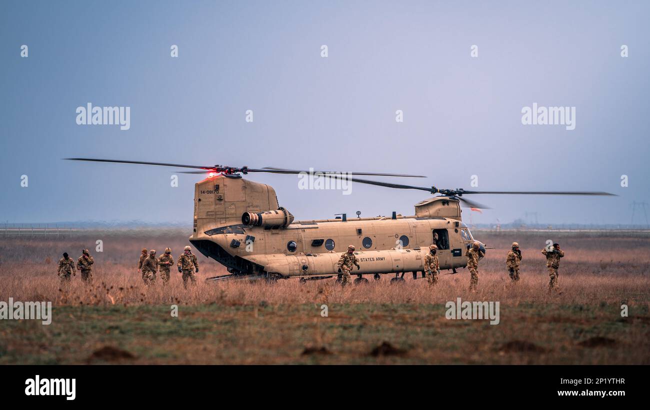 U.S. Army air defenders exit a Chinook helicopter during sling load ...