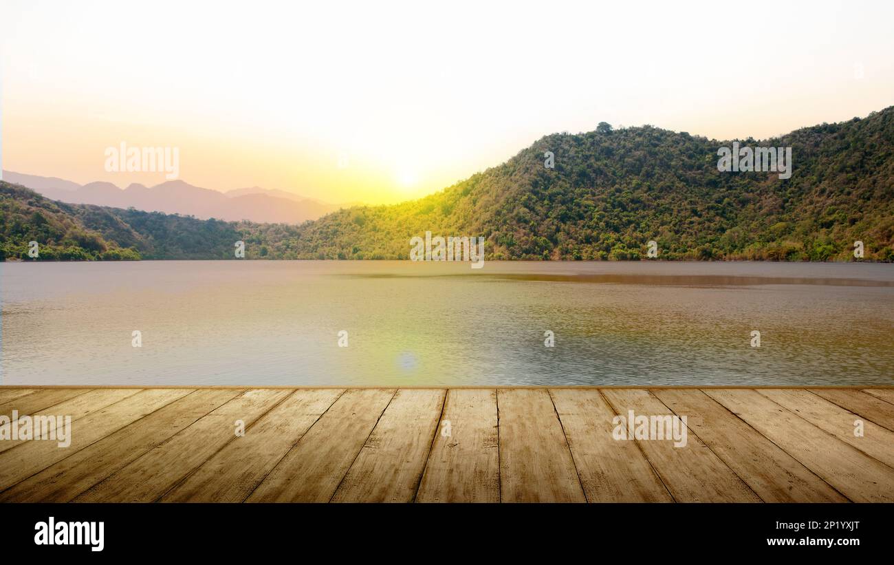 Wooden floor with the landscape of a lake with sunset sky background ...