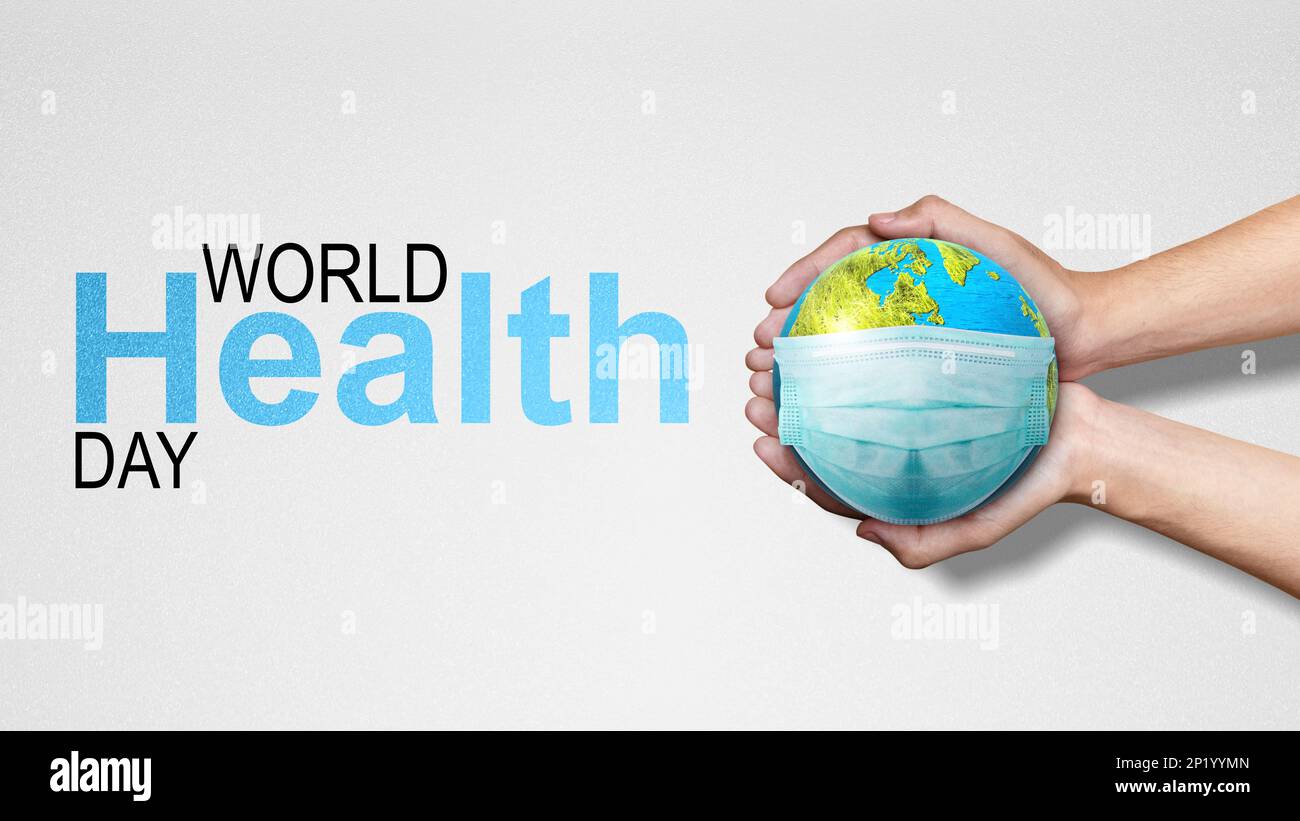 Human hand showing earth with a face mask. World Health Day Concept ...