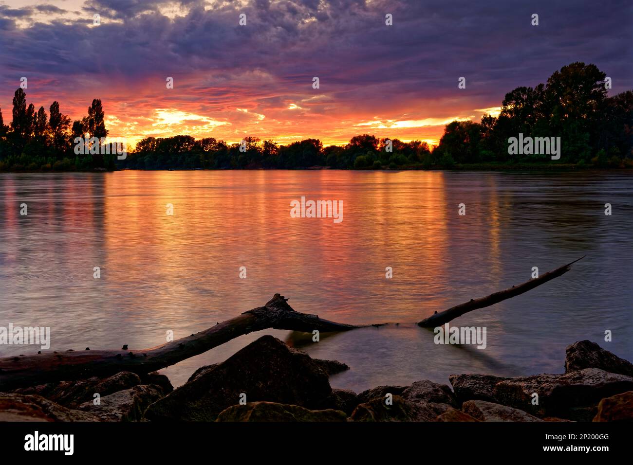 A fantastic sunset at river Rhine. Orange and red clouds reflecting in ...