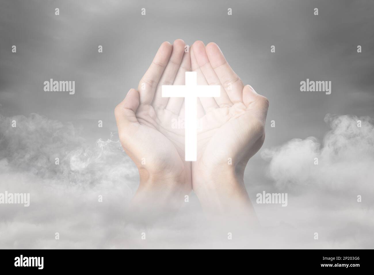 A human hand showing a Christian cross with light background Stock ...