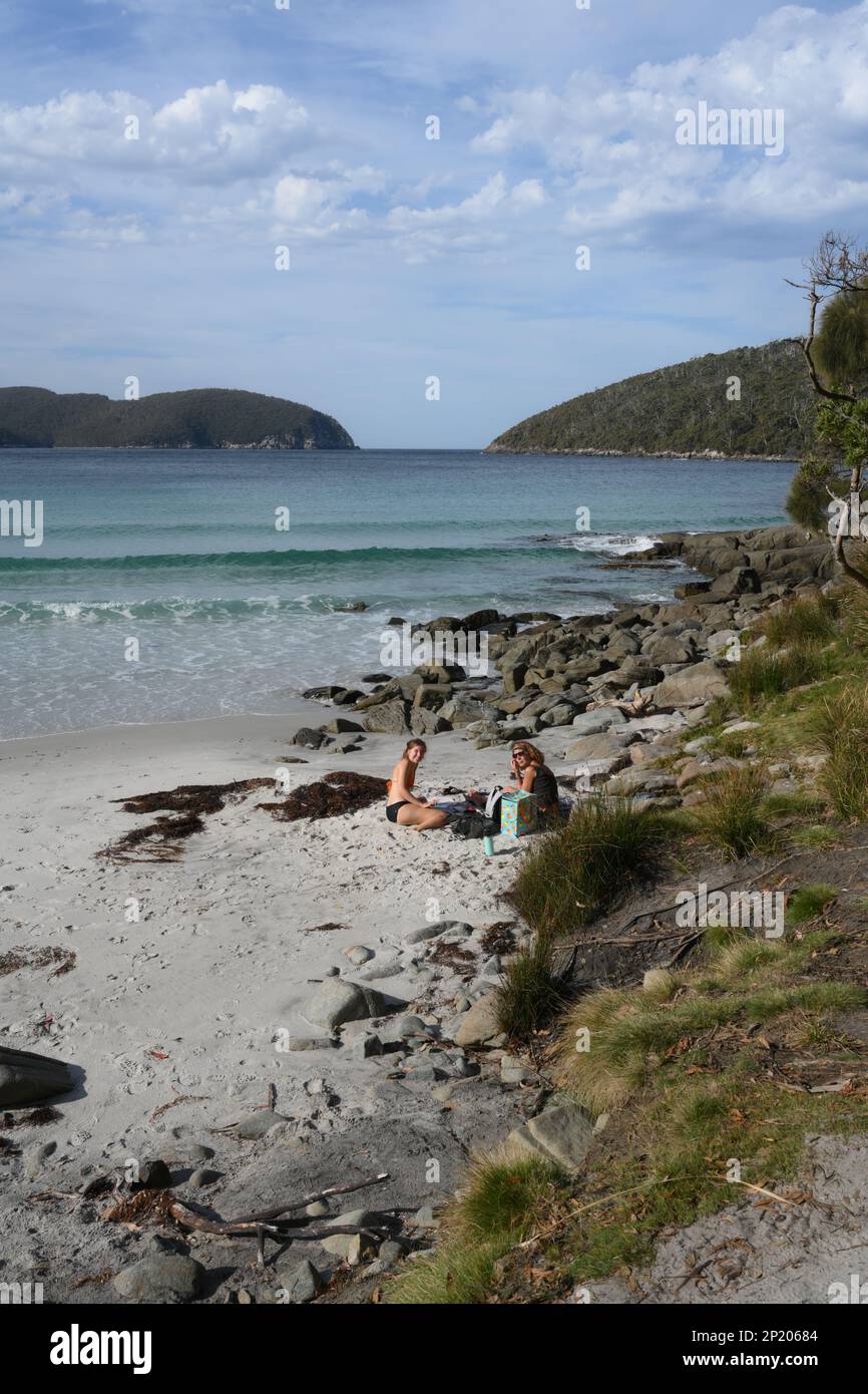 Mother and Daughter painting on the sand at Fortescue bay, Tasman ...
