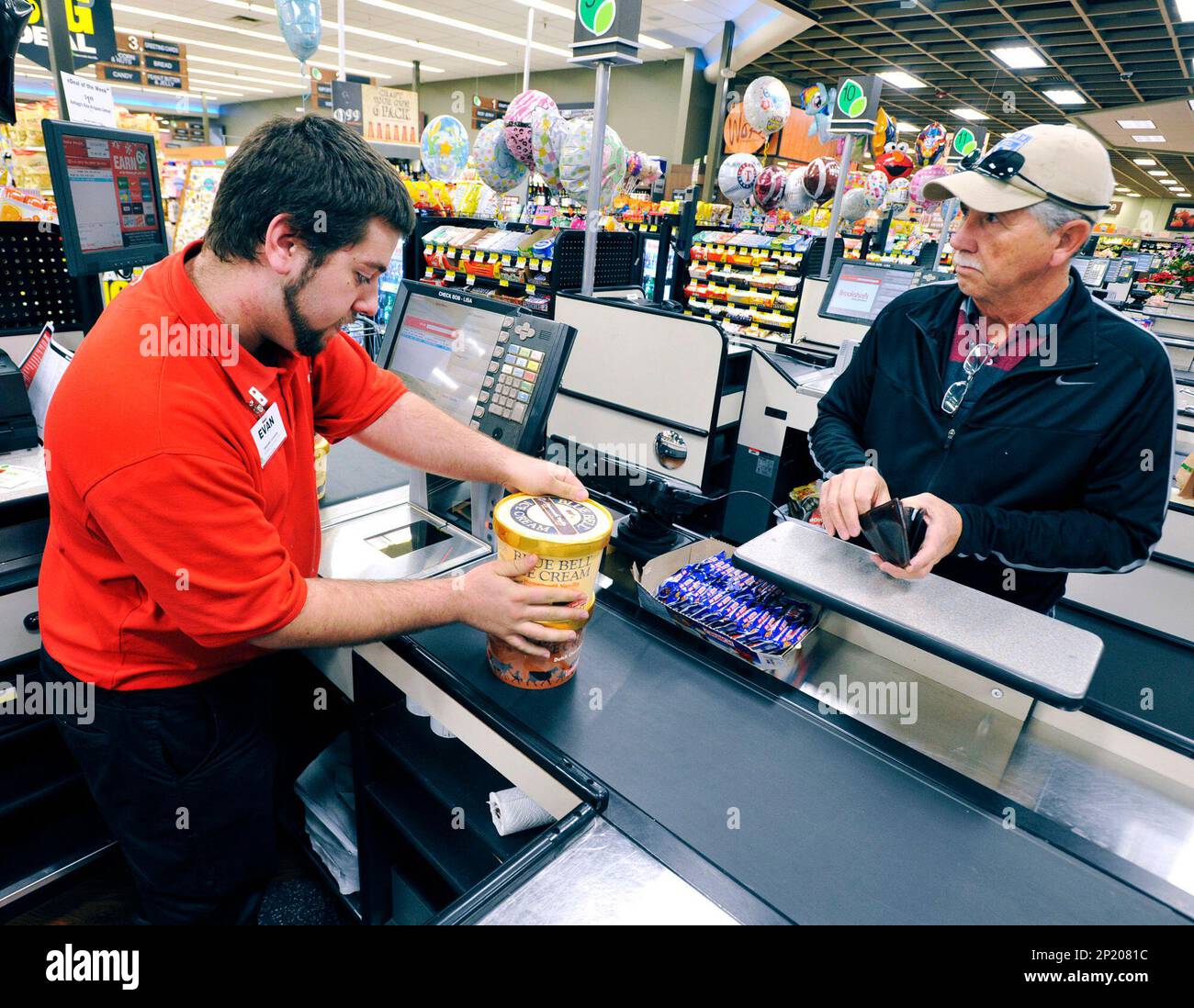 Brookshire Grocery Co. employee Evan Truman, left, runs four, half ...
