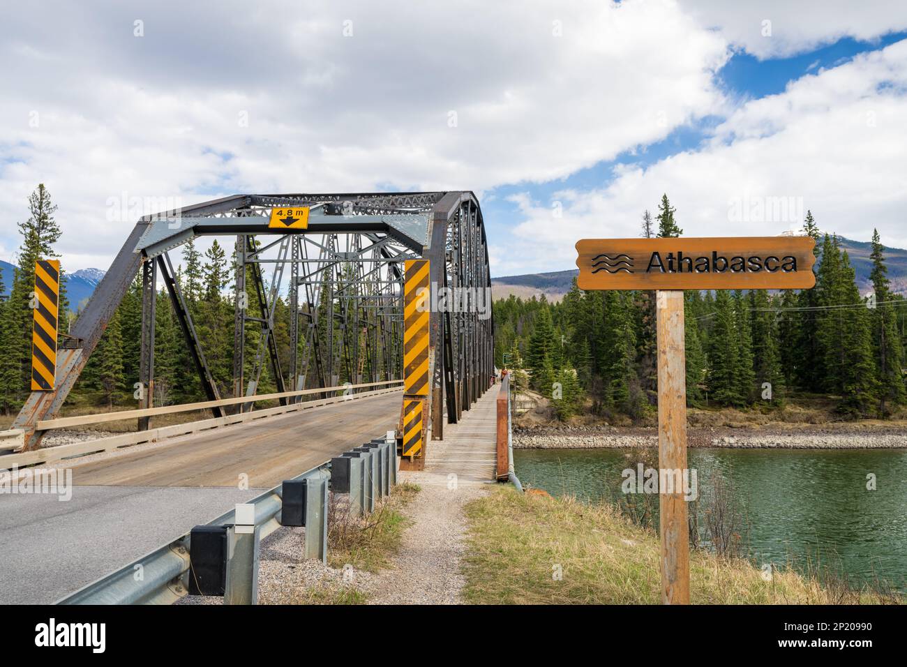 H. J. Moberly Bridge. Athabasca River under blue sky and white clouds ...