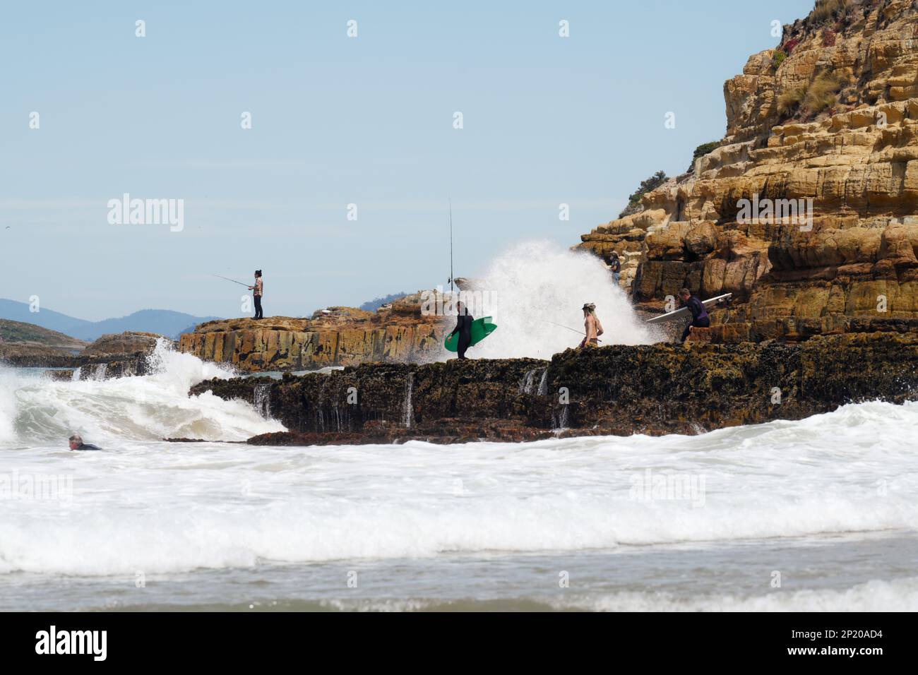 Fisherman and surfers enjoy the beach surf at Goats Bluff, Tasmania ...