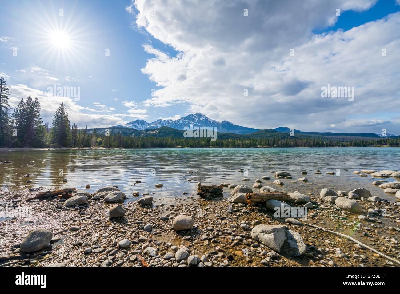 Lake Annette lake shore beach, Pyramid mountain reflection on the lake ...