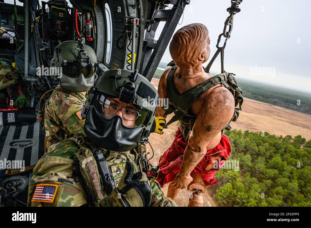 U.S. Army Staff Sgt. Anthony Marotta, center, and Sgt. Jeff Angle, UH ...