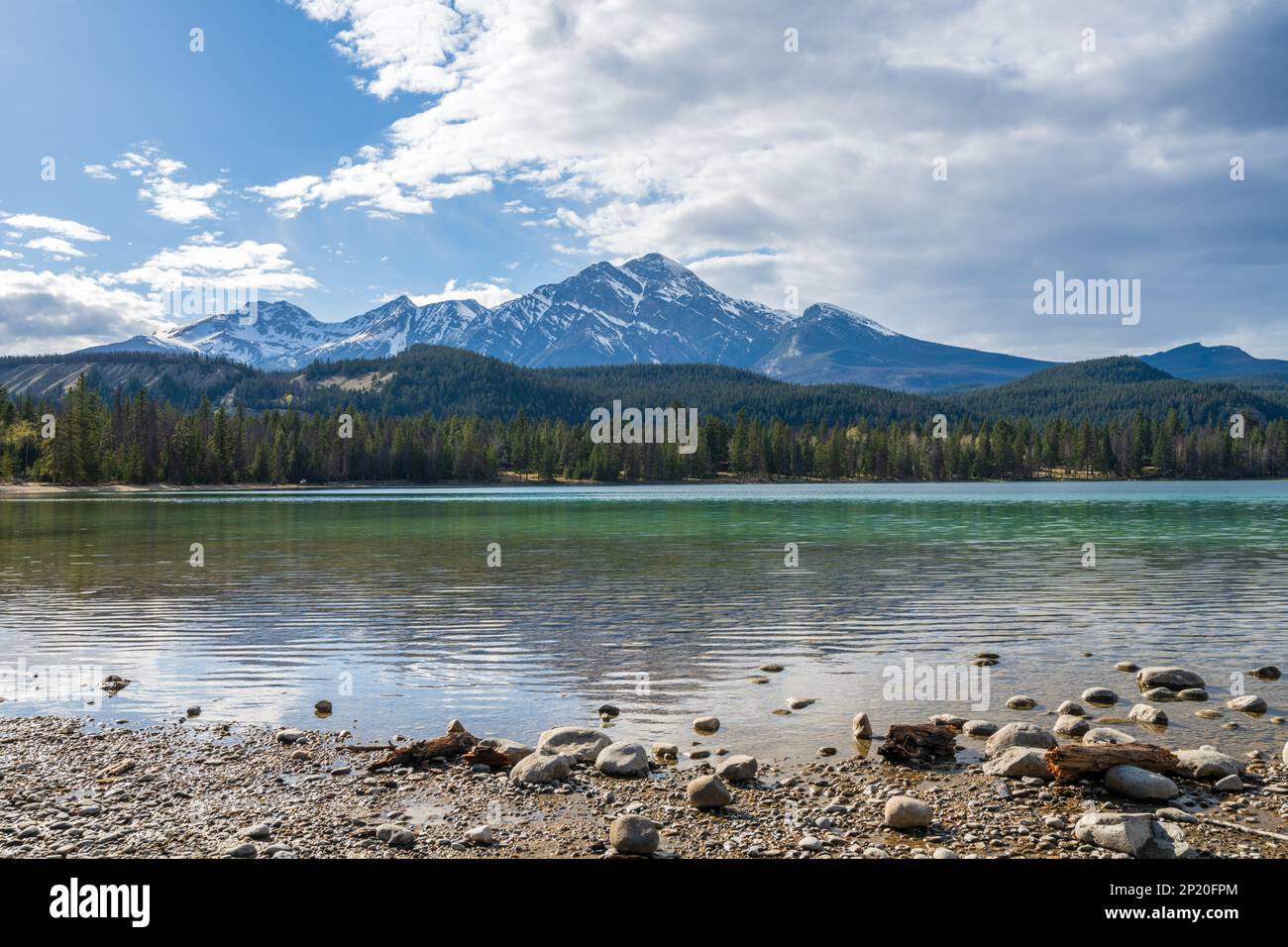 Lake Annette lake shore beach, Pyramid mountain reflection on the lake ...