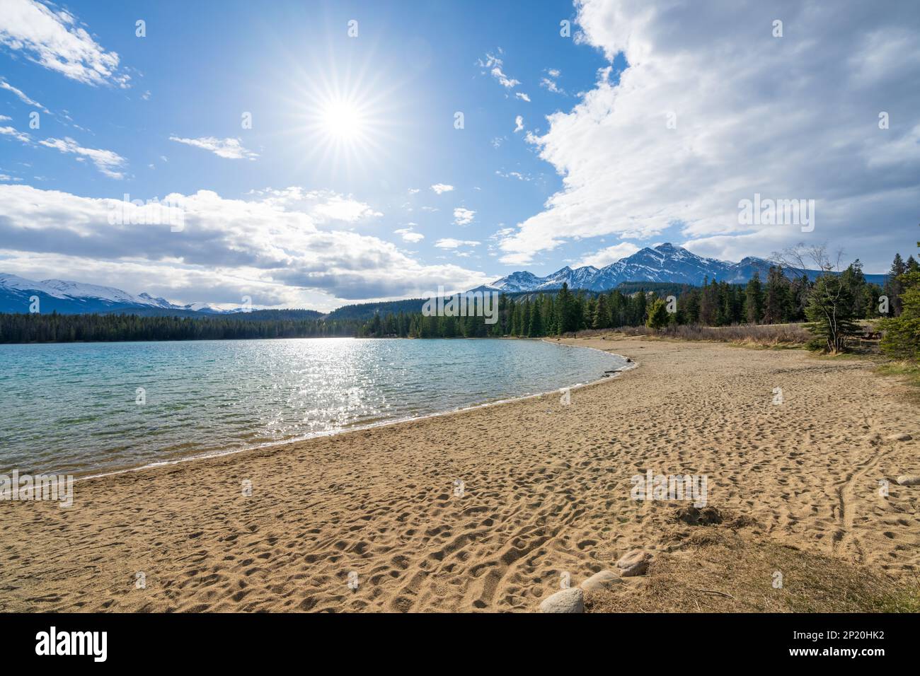 Lake Annette lake shore beach, Pyramid mountain reflection on the lake ...