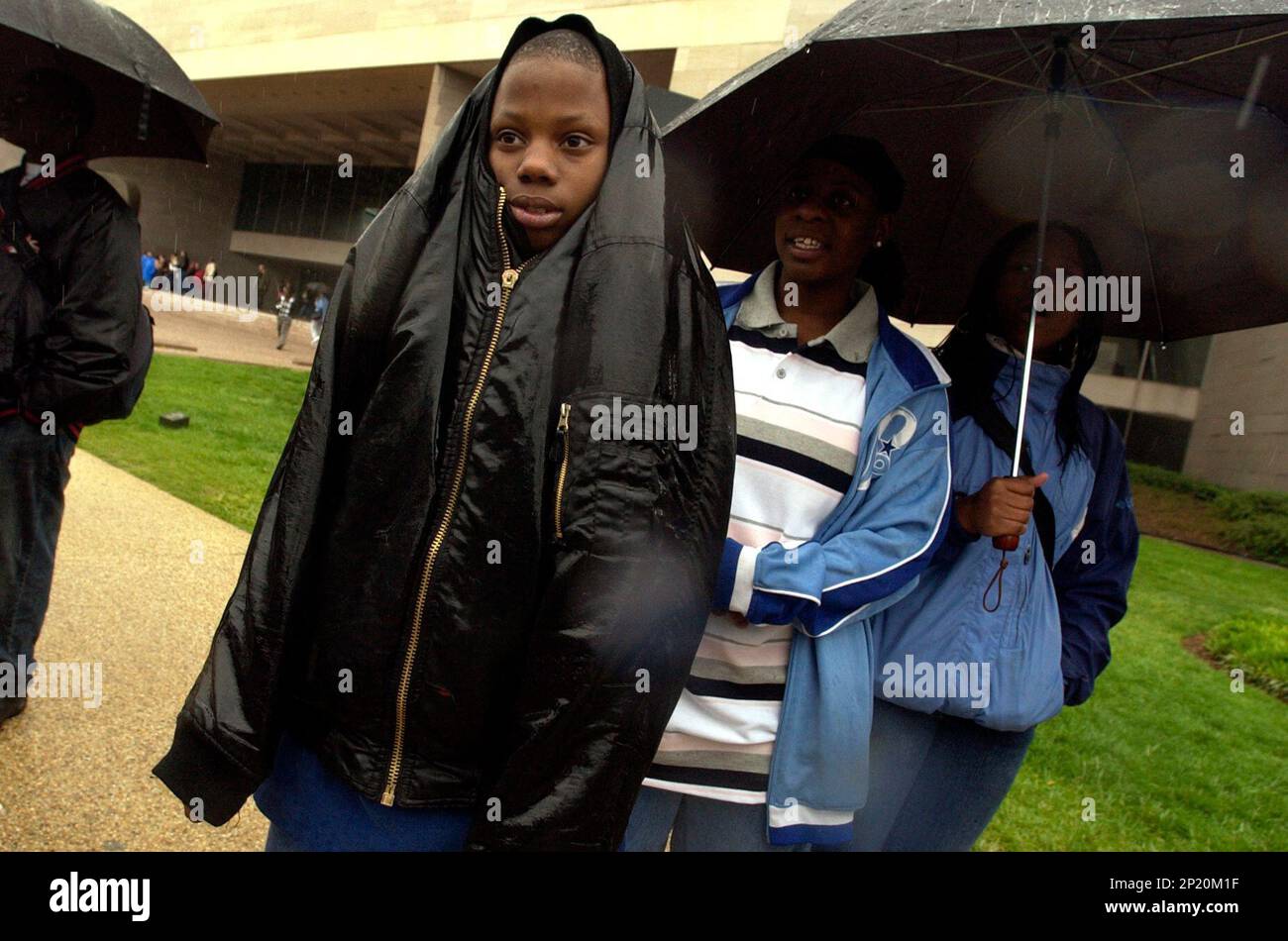 Donnell Phillips, 13, of Eastern High School in NE, shelters himself ...