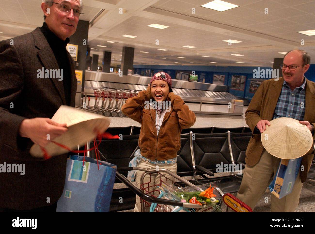 Thuy Anh gives Chuck Atkins, left, and Larry Cosgriff traditional ...