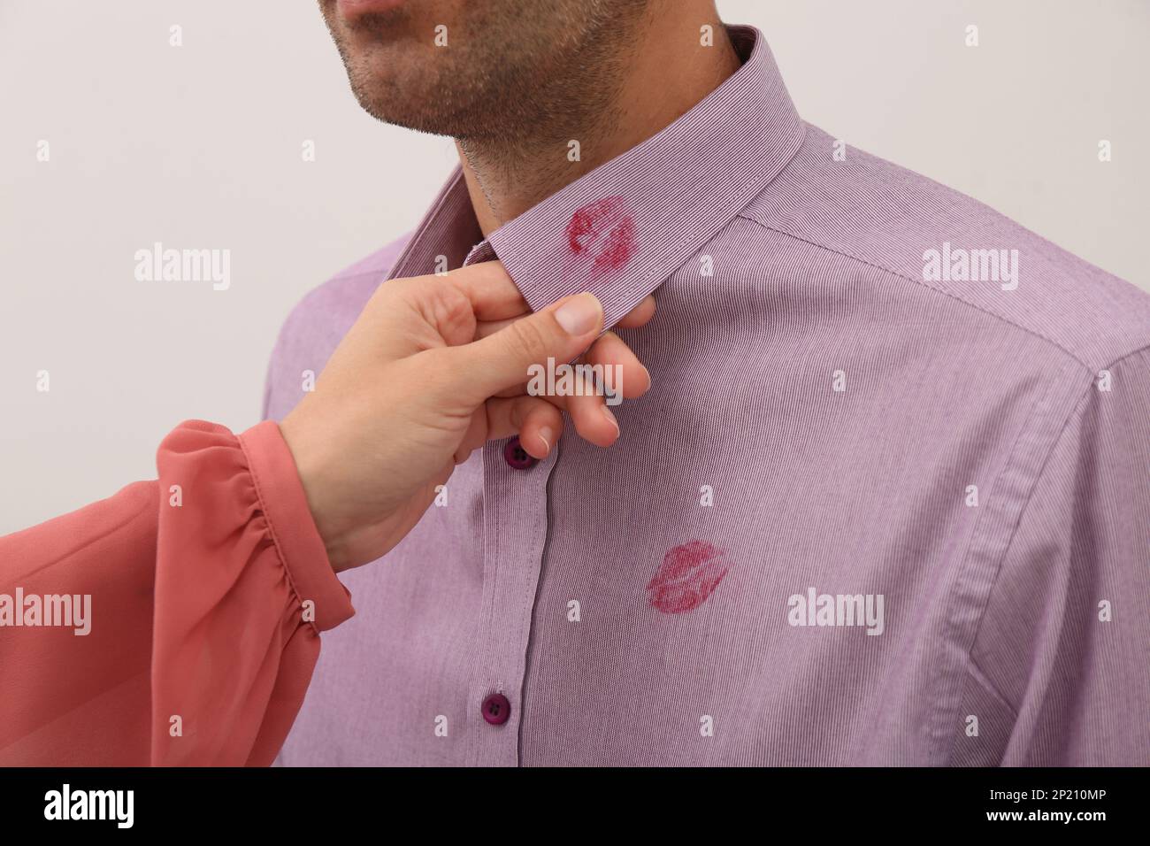 Woman noticed lipstick kiss marks on her husband's shirt against white ...