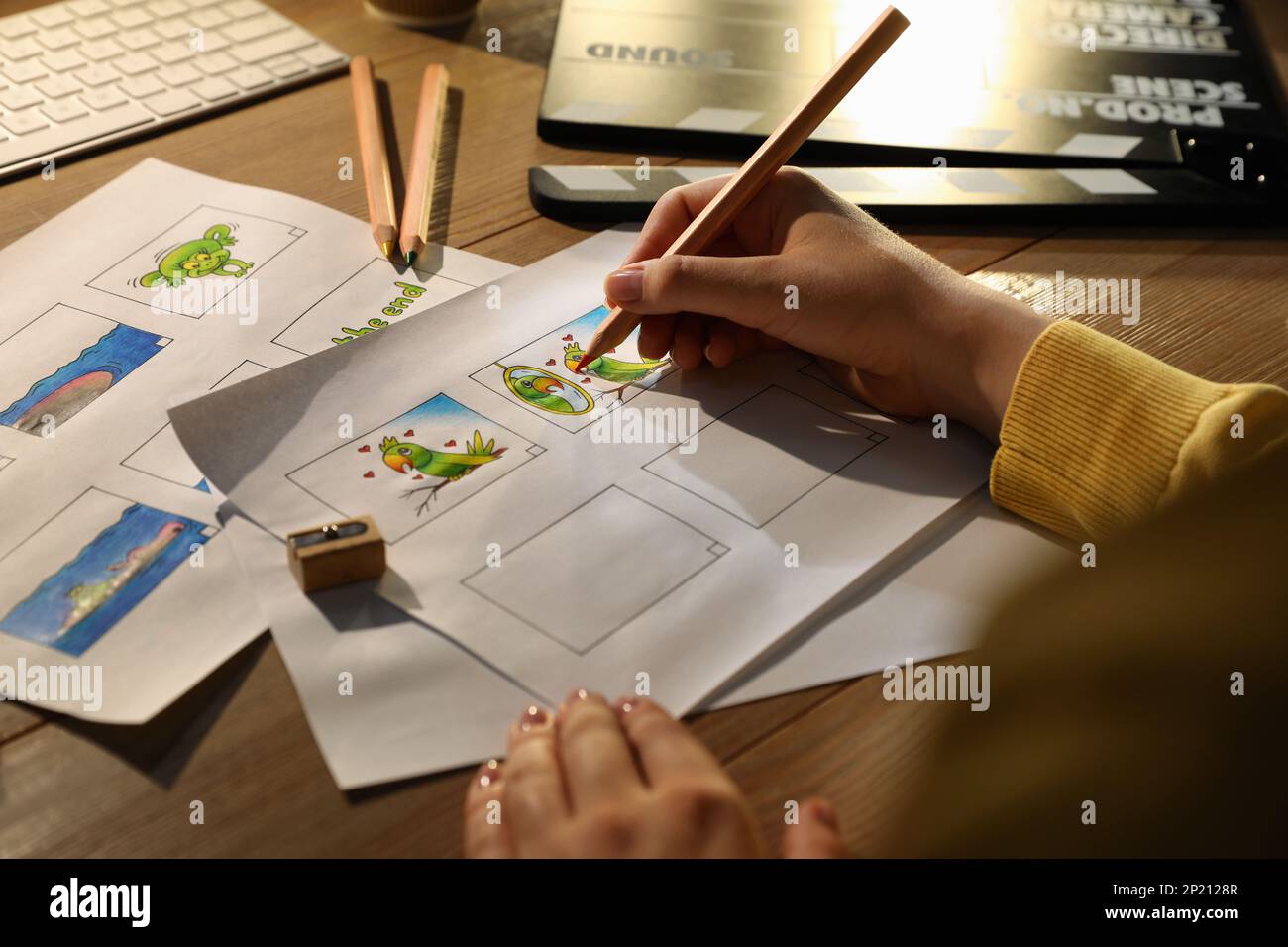 Woman drawing cartoon sketches at workplace, closeup. Pre-production ...