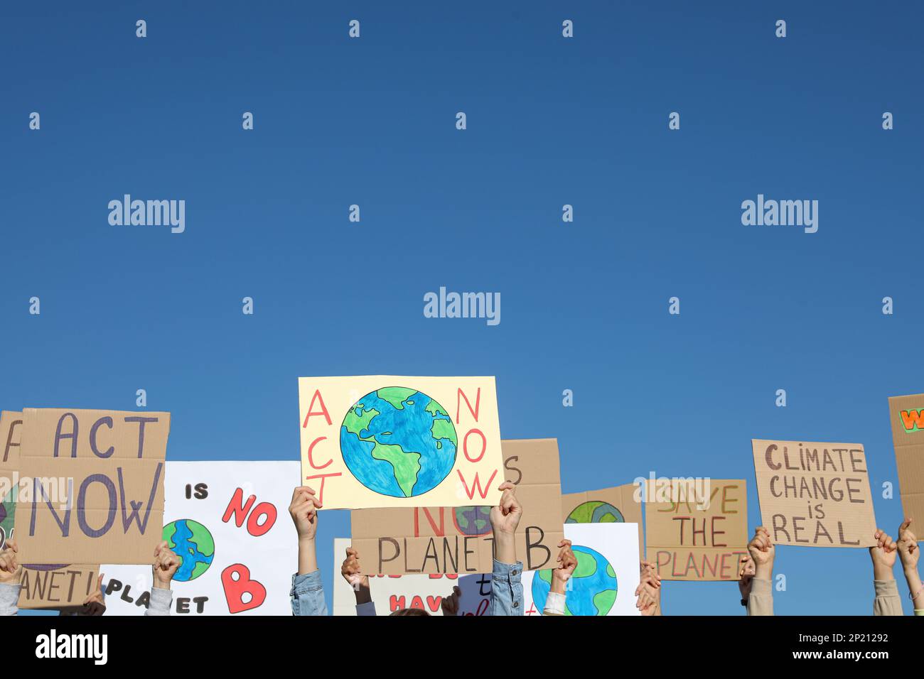 Group of people with posters protesting against climate change outdoors ...