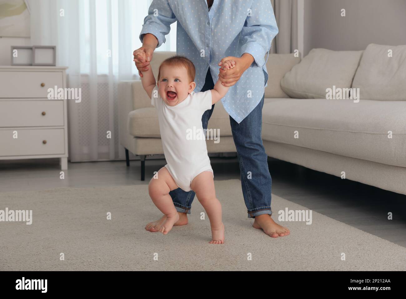 Mother teaching her little baby to walk at home Stock Photo - Alamy