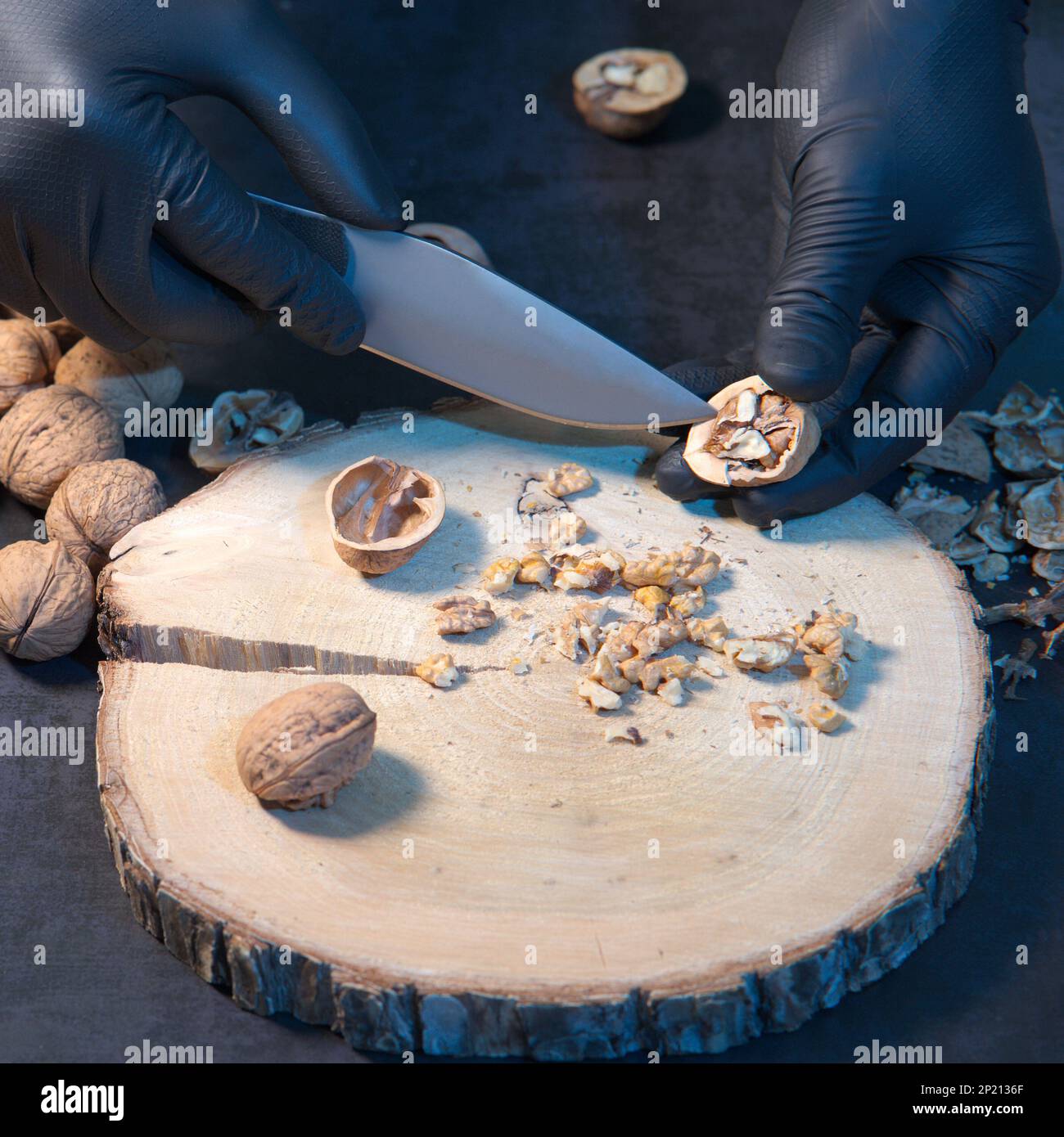 Chef peeling walnuts with a knife in the kitchen at the table Stock ...