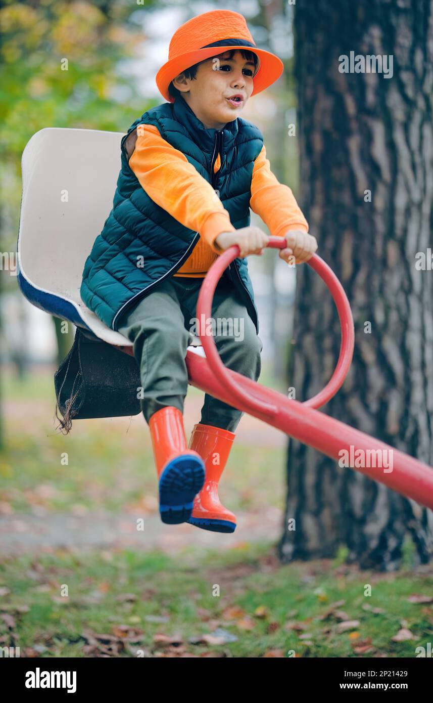 A little boy rides on a swing. Real emotions. motion blur Stock Photo ...