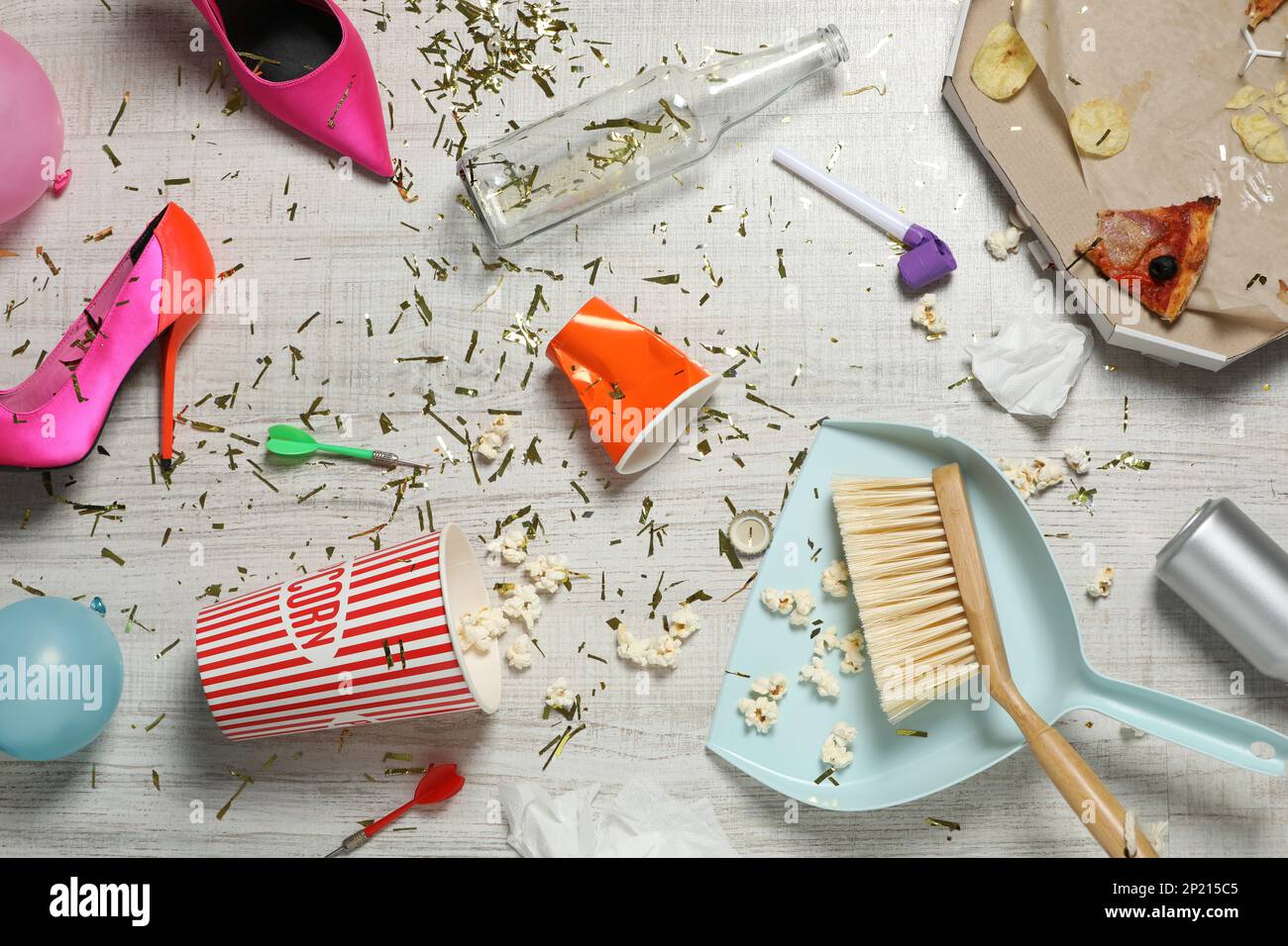 Brush and dustpan on messy floor after party, flat lay Stock Photo - Alamy