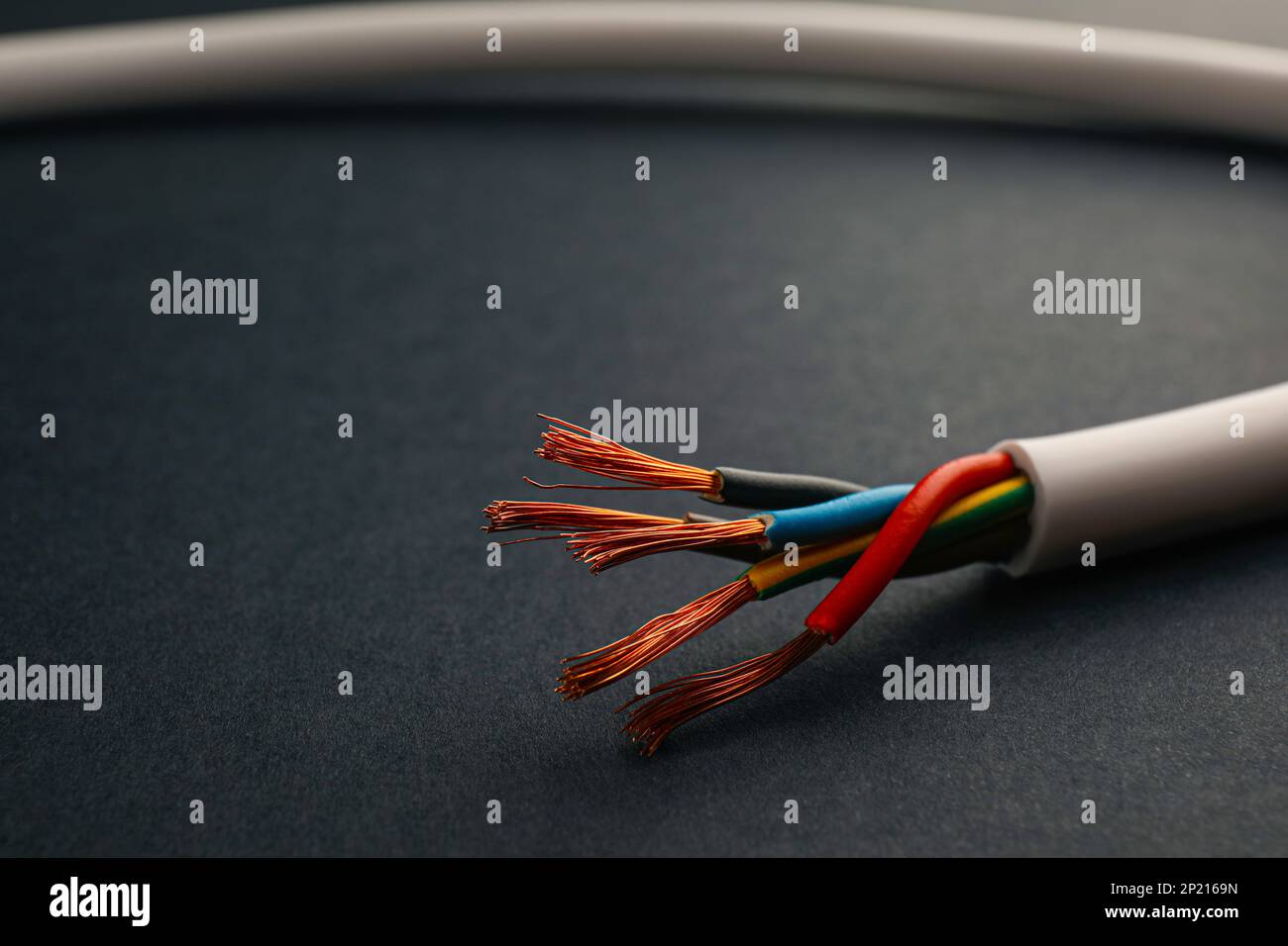 Cable with stripped wires on black background, closeup Stock Photo - Alamy