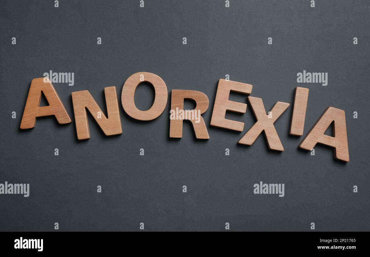 Word Anorexia made of wooden letters on dark grey background, flat lay ...