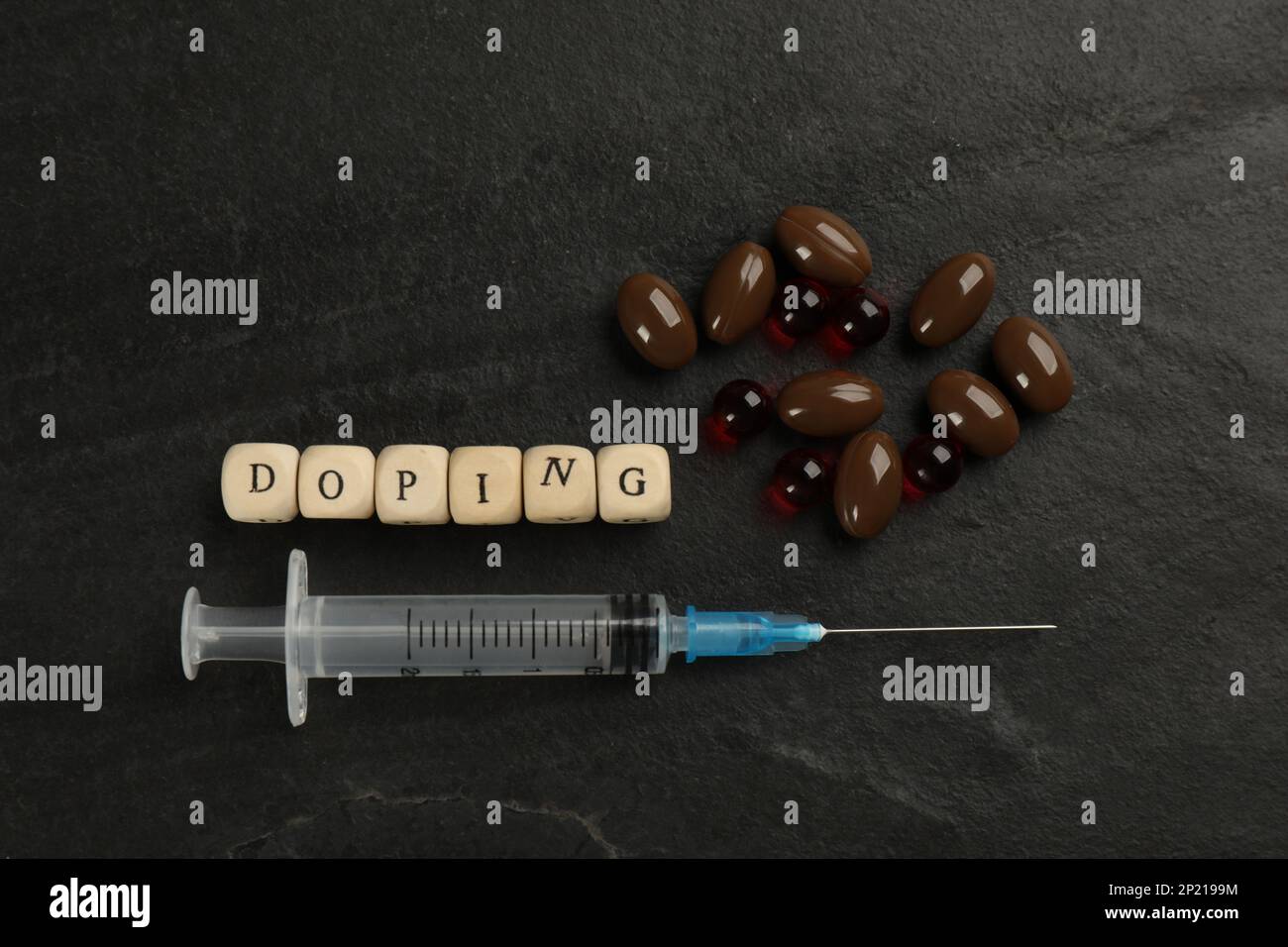 Wooden cubes with word Doping and drugs on black background, flat lay ...