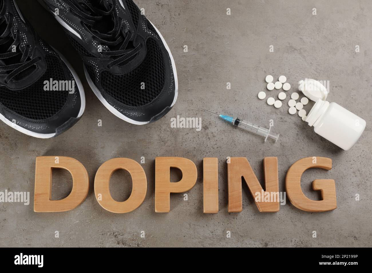 Word Doping, sport shoes and drugs on grey background, flat lay Stock ...