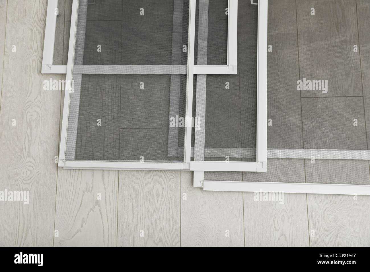 Set of window screens on wooden floor, flat lay Stock Photo - Alamy