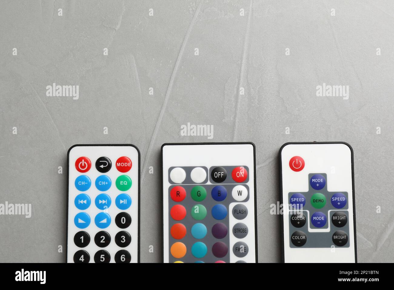 Remote controls on grey table, flat lay. Space for text Stock Photo - Alamy