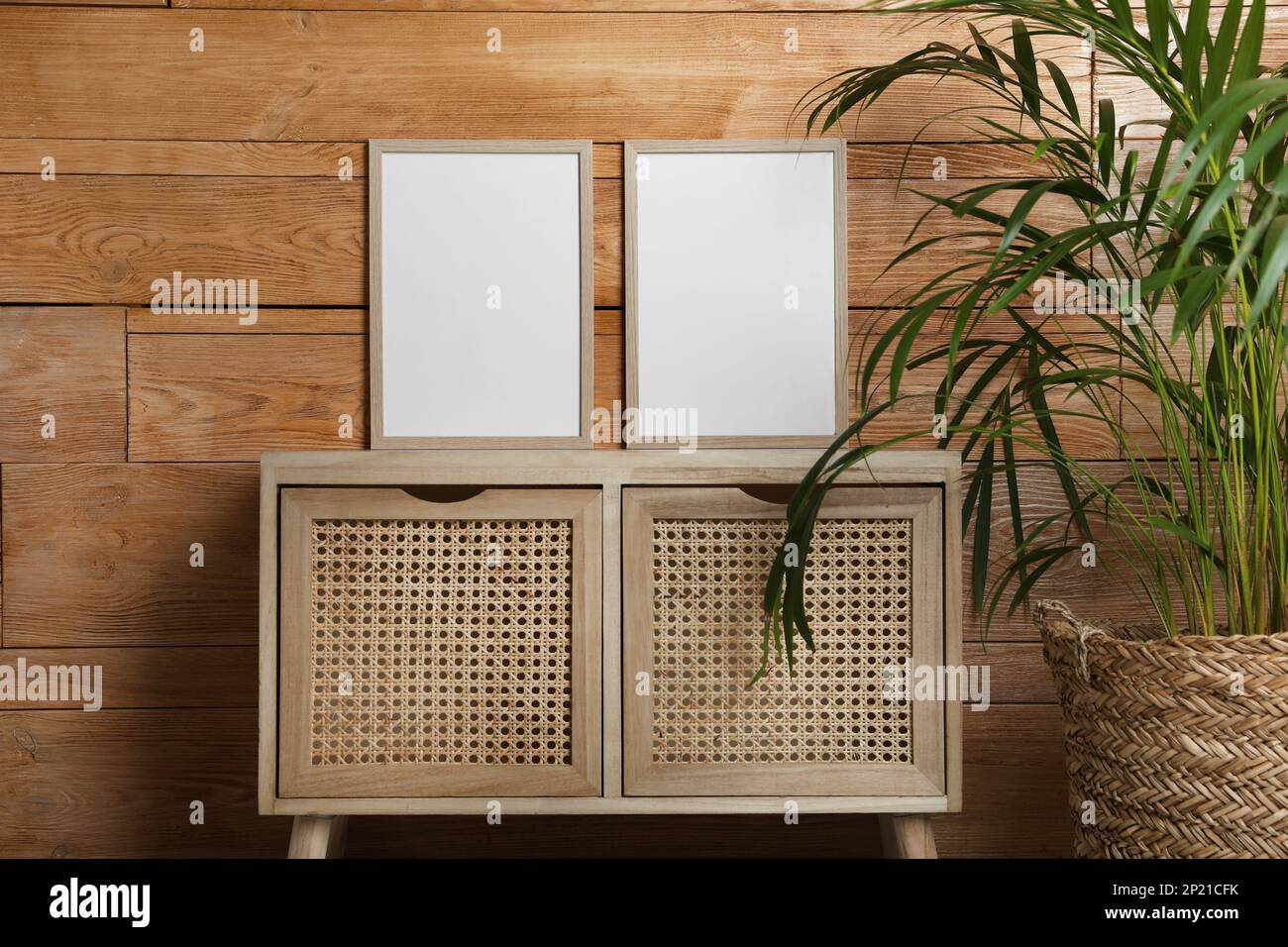 Empty frames on table near wooden wall. Mockup for design Stock Photo ...