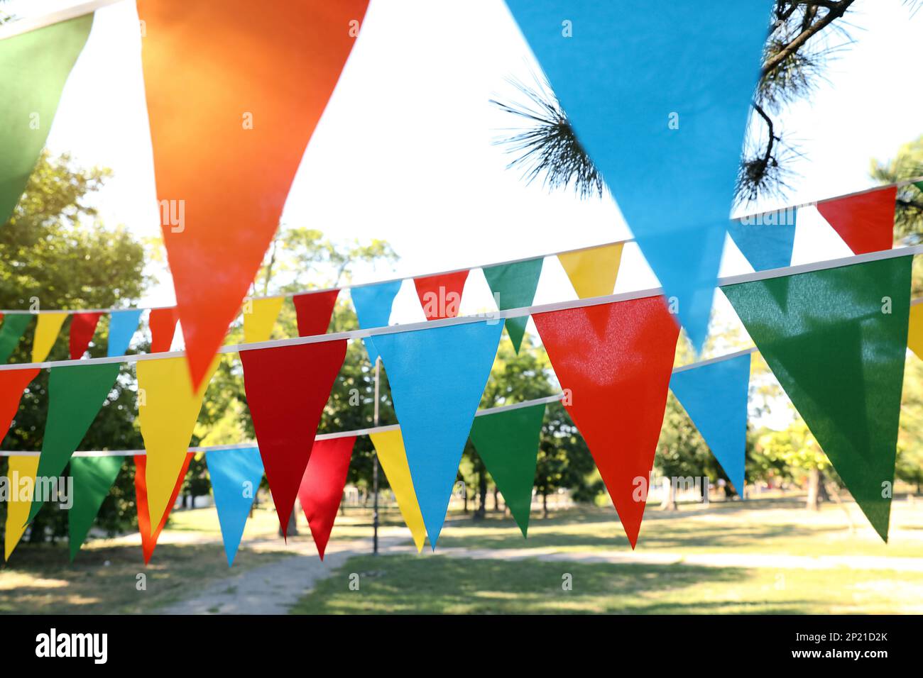 Colorful bunting flags in park. Party decor Stock Photo - Alamy