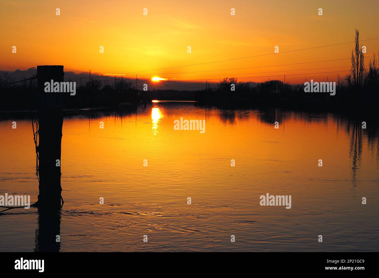 Reflection of the sun over the marsh (Porto Corsini Stock Photo - Alamy