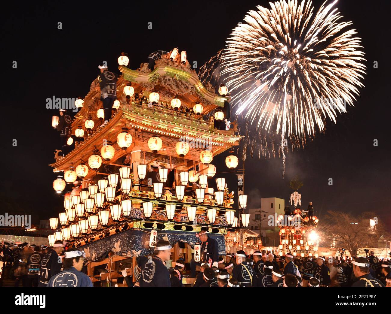 People carry a mikoshi and floats with fireworks during the Chichibu ...