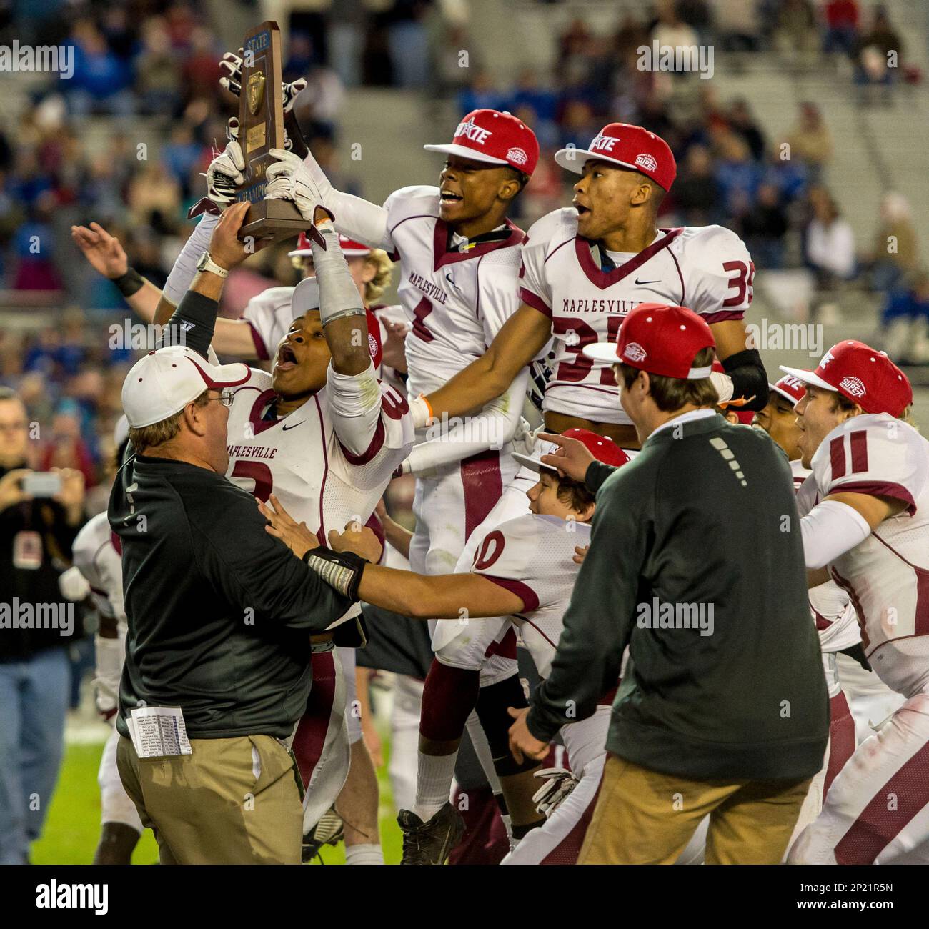 Maplesville players surround Maplesville coach James Hubbert and the ...