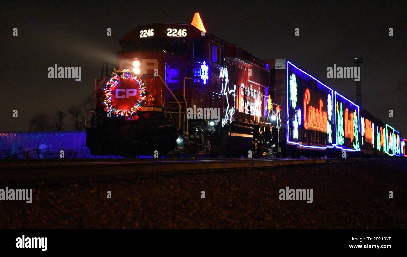 The Canadian Pacific Holiday Train, lit with bright blinking lights of ...
