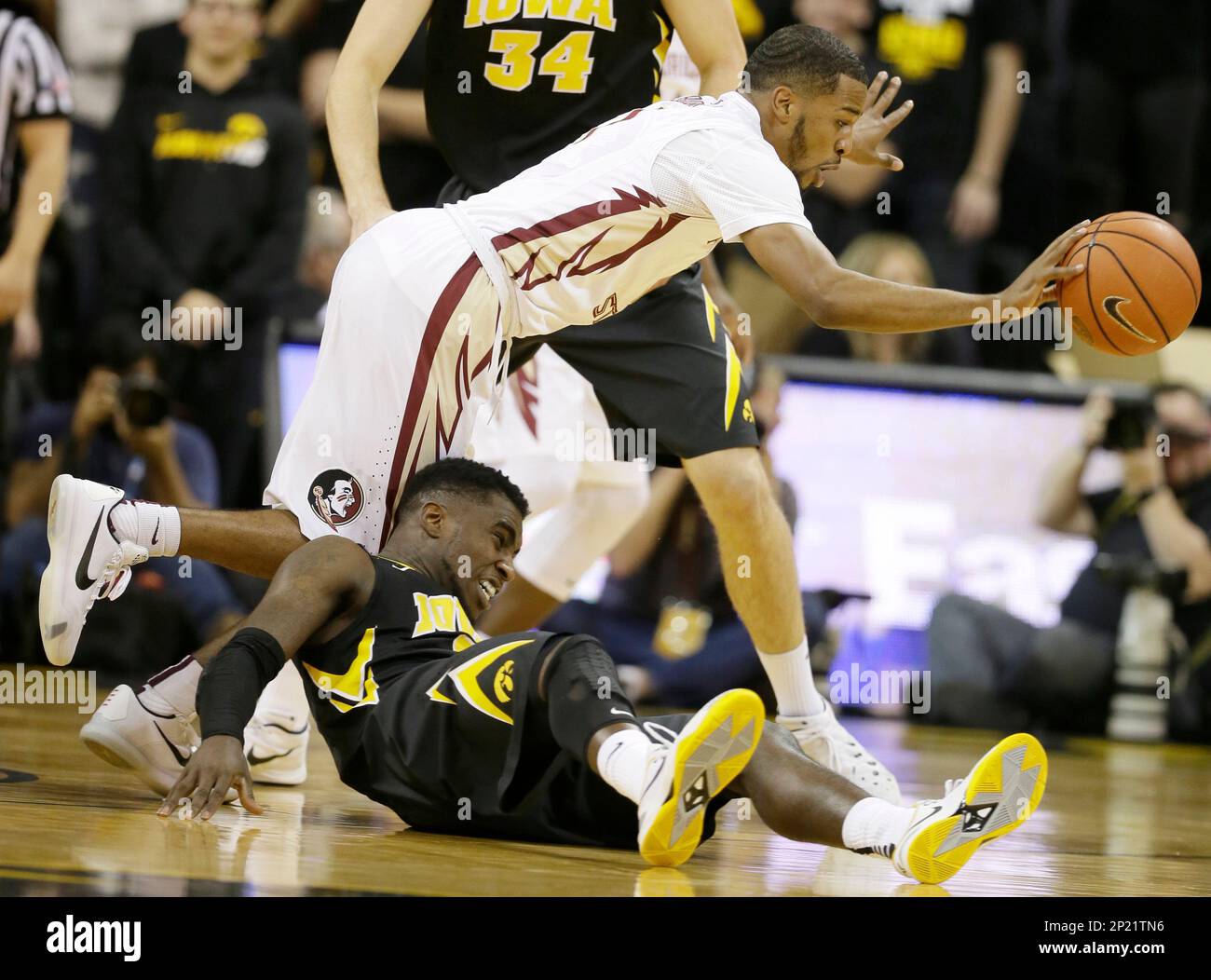 Florida State guard Devon Bookert, top, steals the ball from Iowa guard ...