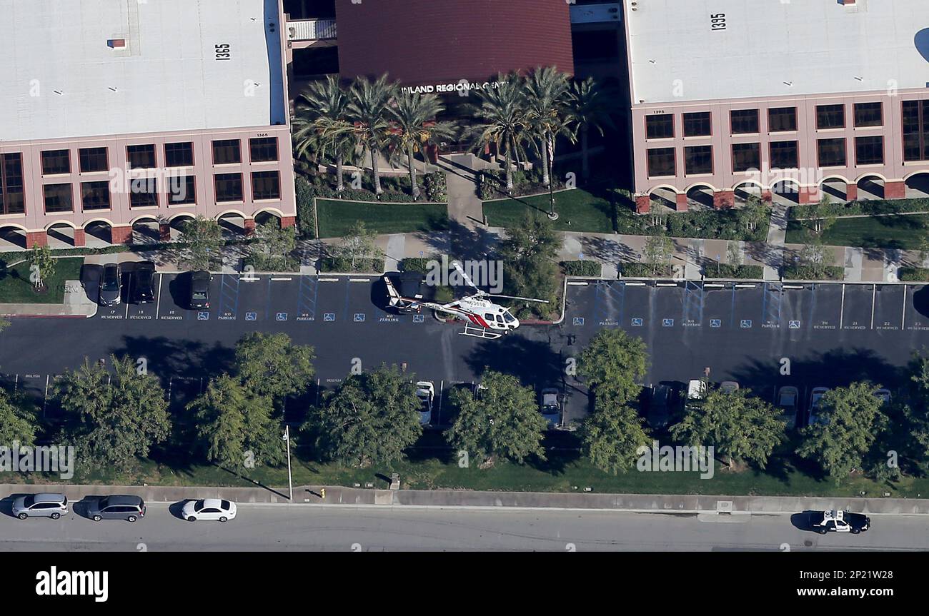 A police heicopter hovers around the Inland Regional Center in San ...