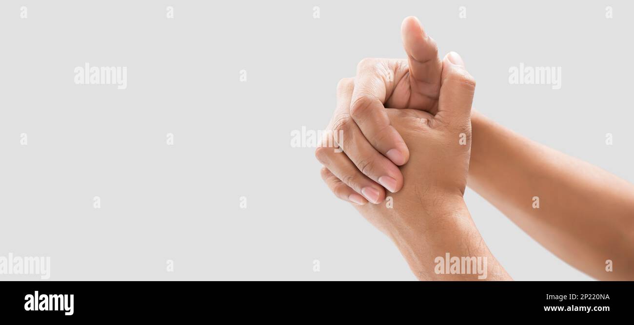 A man cracking their knuckles. On a gray background. Copy space Stock ...